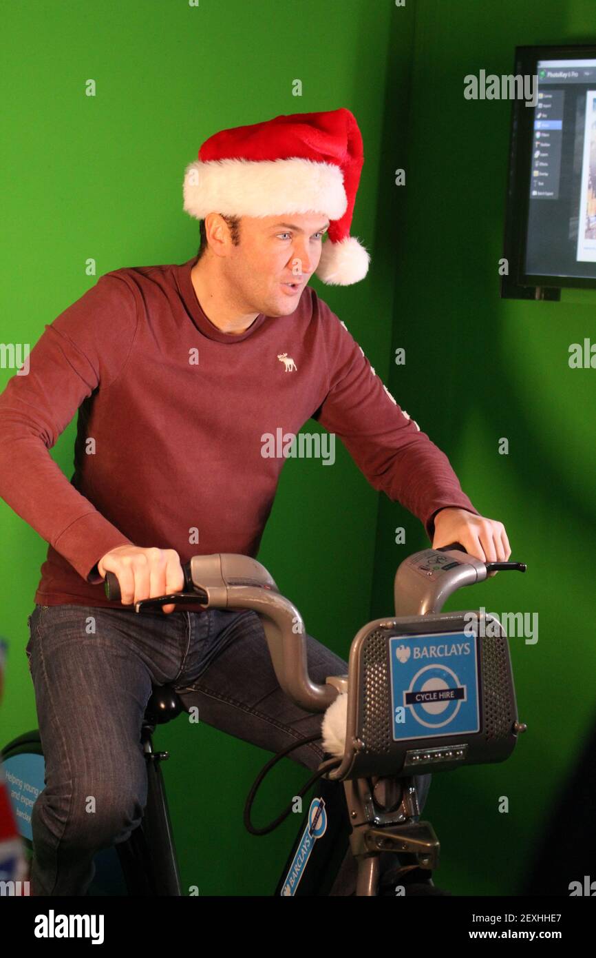 London, UK 16 November 2014. A man poses for photos on a Boris bike ...