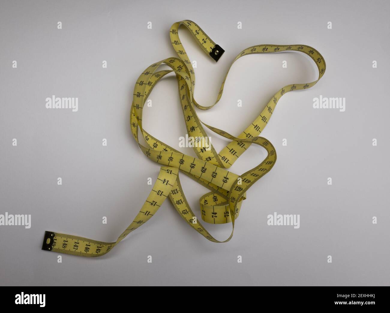 An overhead shot of a sewing kit measuring tape on a white background ...