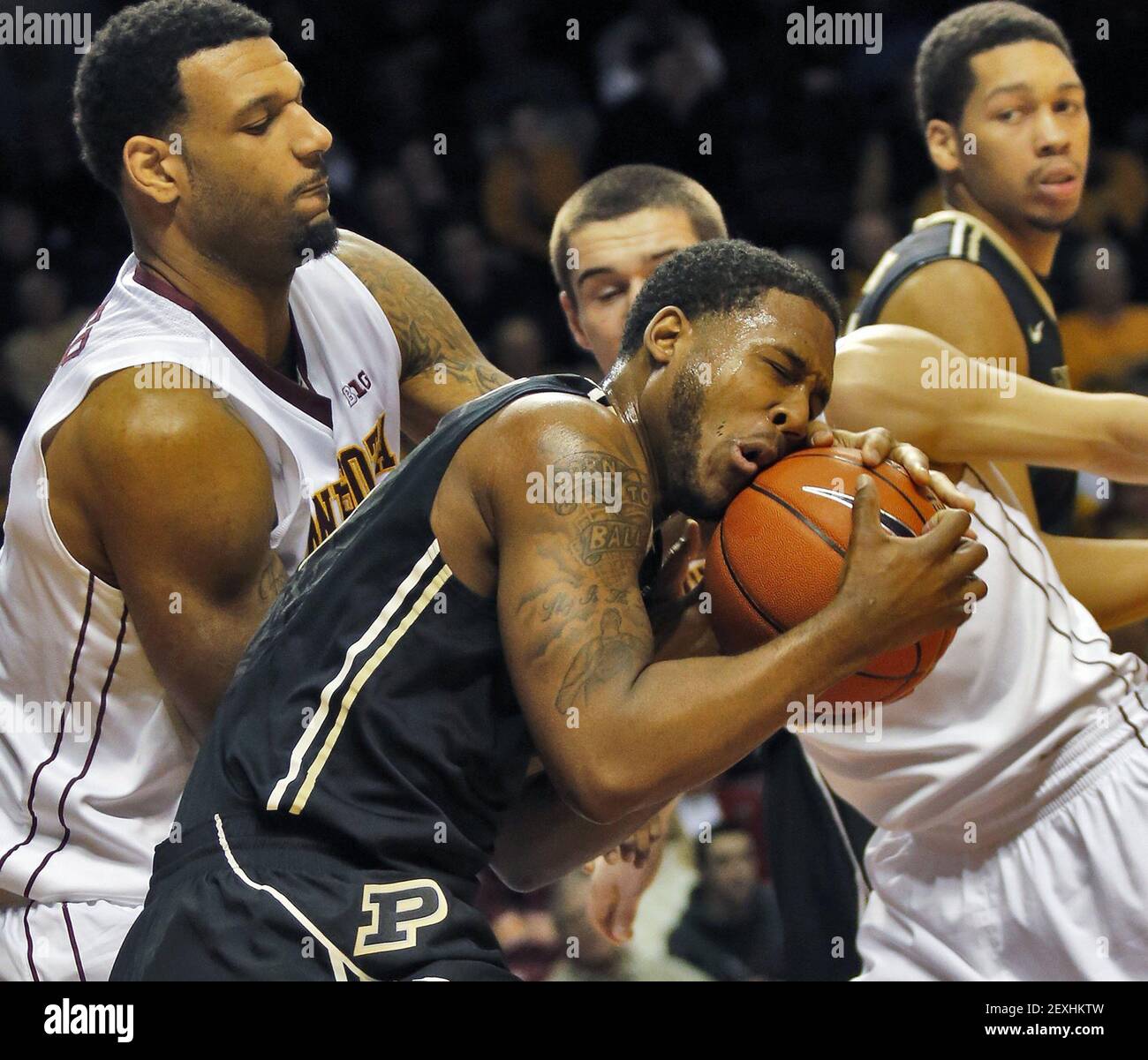 Minnesota's Maurice Walker, left, and Joey King apply defensive ...