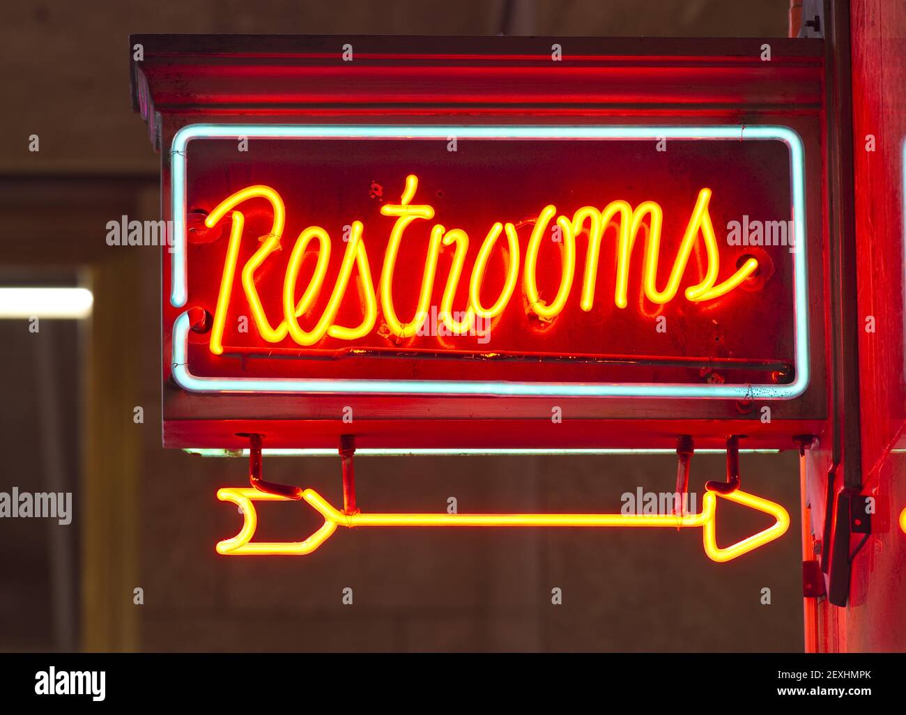Red Neon Restrooms Sign Indoor Signage Arrow Pointing Stock Photo - Alamy