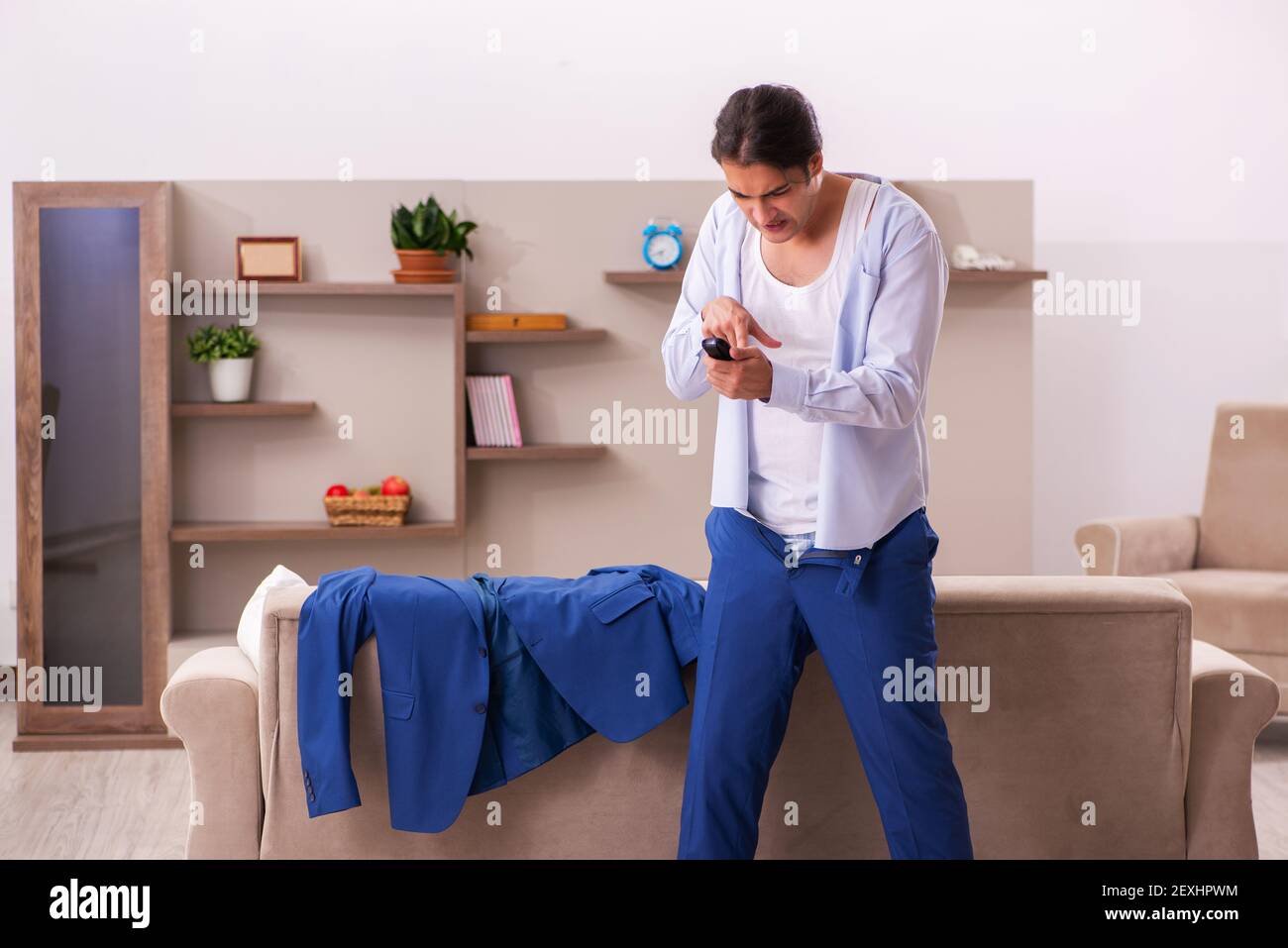 Young employee getting up late at home Stock Photo - Alamy