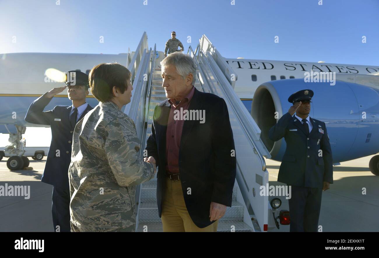 Secretary of Defense Chuck Hagel, center right, is greeted by U.S. Air ...
