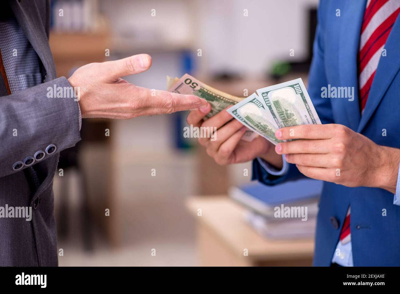 Two employees in remuneration concept Stock Photo - Alamy