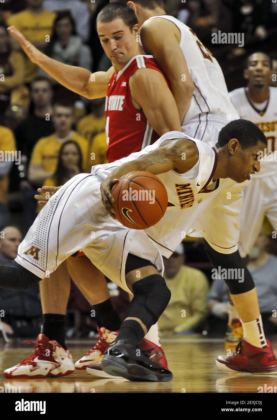Minnesota's DeAndre Mathieu works his way around the defense of Ohio ...