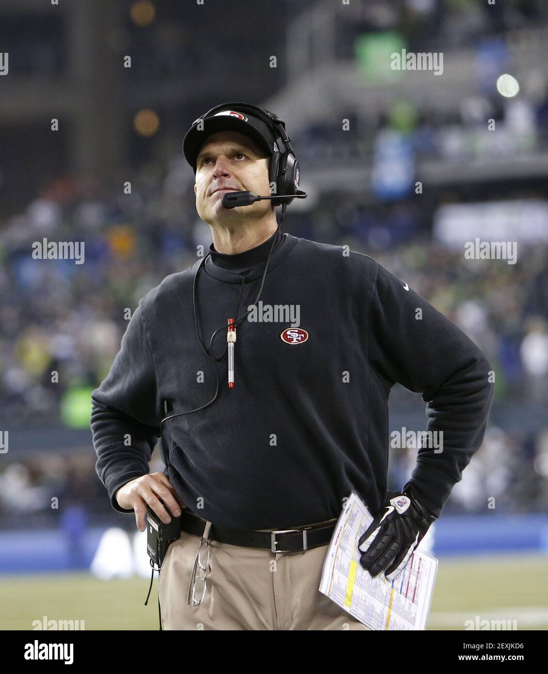 San Francisco 49ers head coach Jim Harbaugh reacts as he watches the ...