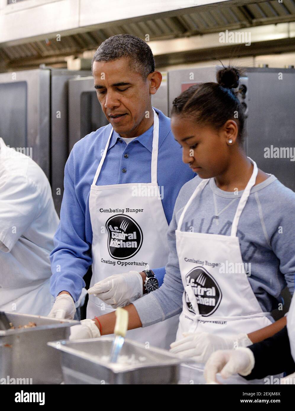 President Barack Obama with daughter Sasha participate in a community ...