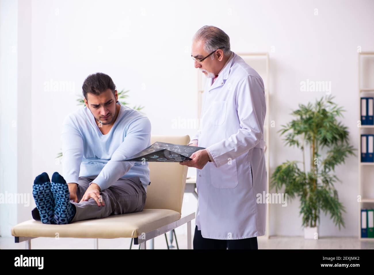Sick man visiting old doctor radiologist Stock Photo - Alamy