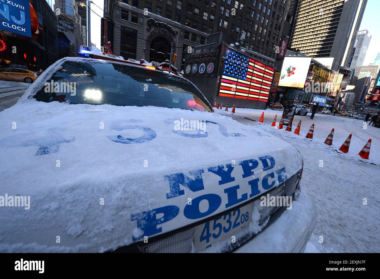 NYPD squad cars covered in snow and ice are parked in Times Square the ...