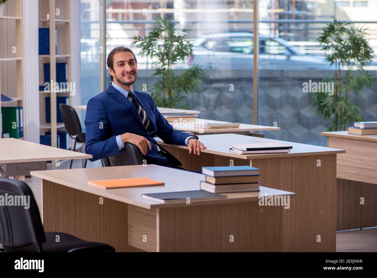 Young teacher in suit in the classroom Stock Photo - Alamy