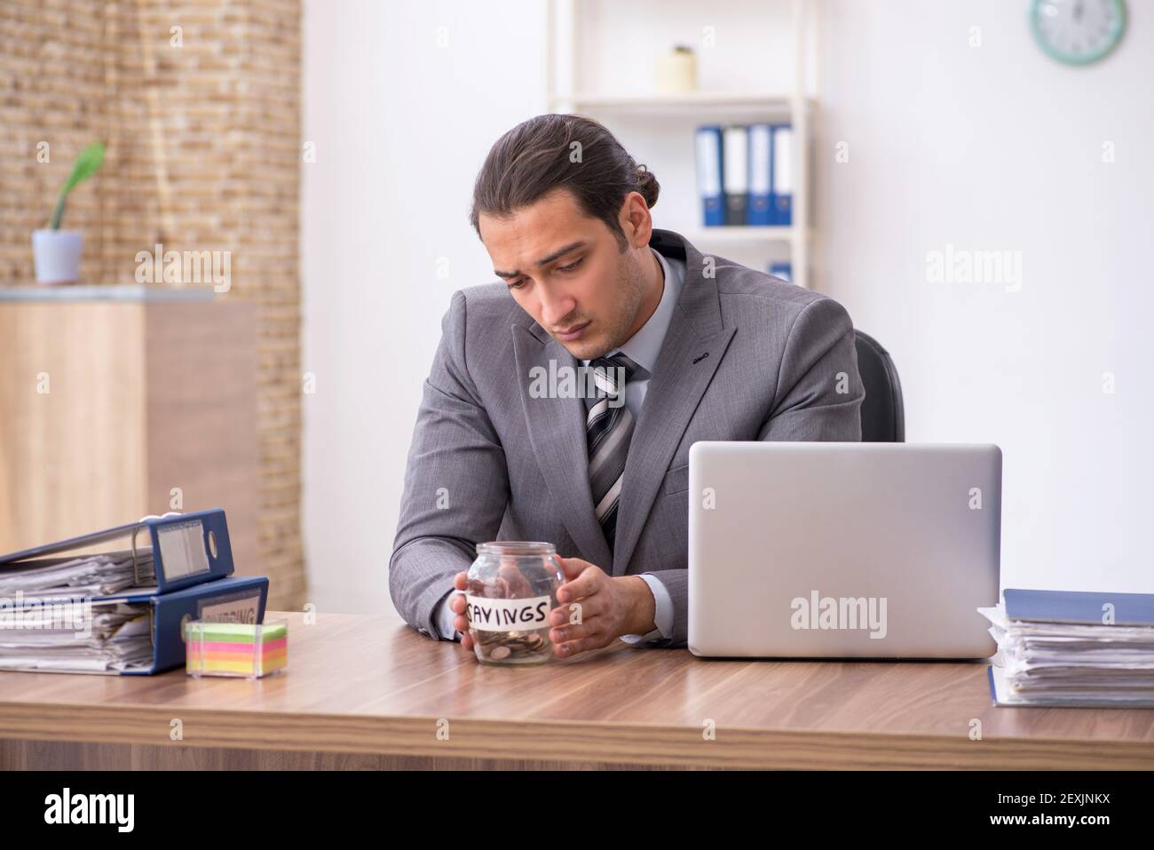 Young employee in pension concept at workplace Stock Photo - Alamy