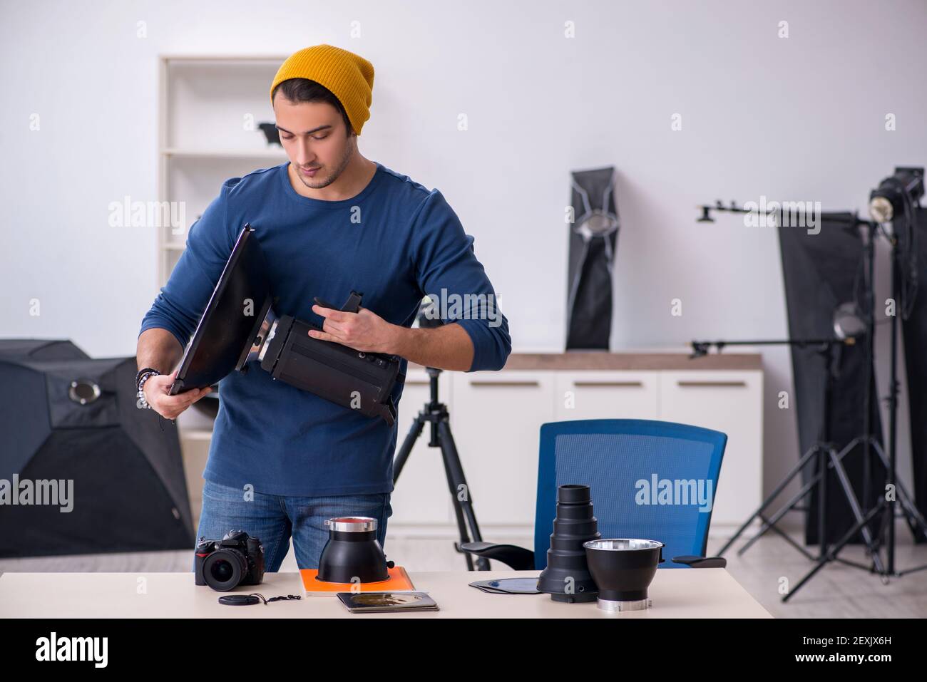 Photographer in studio adjusting dslr hi-res stock photography and ...