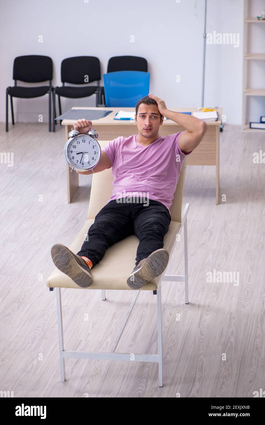 Male patient waiting for doctor in time management concept Stock Photo ...