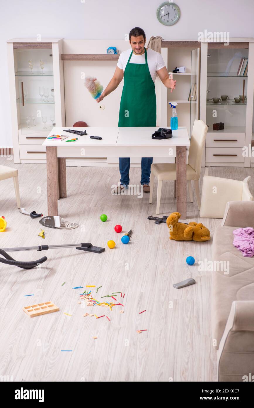 Young contractor cleaning the flat after kids' party Stock Photo - Alamy