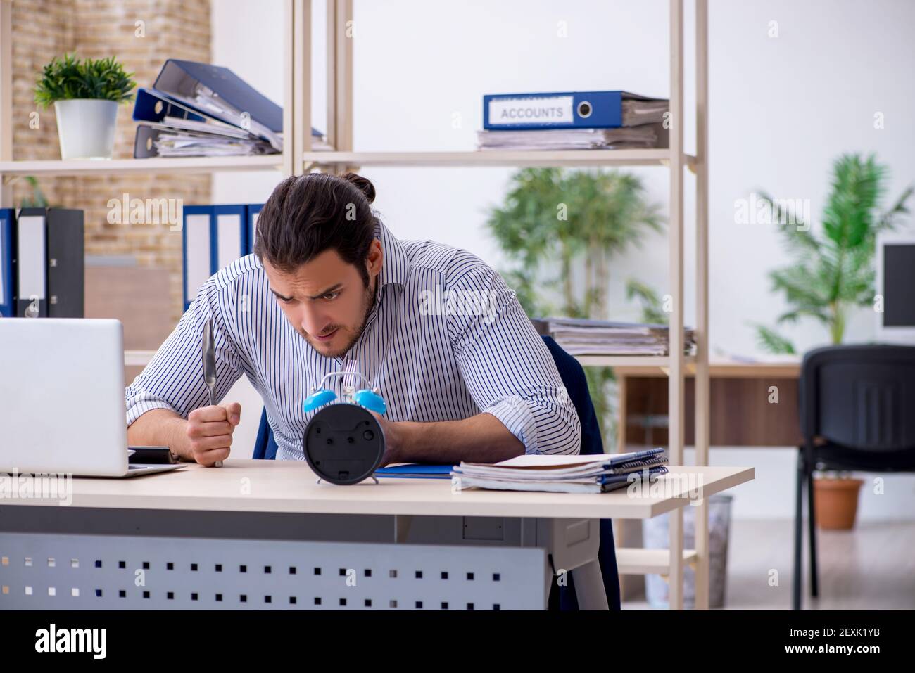 Hungry employee waiting for food in time management concept Stock Photo ...