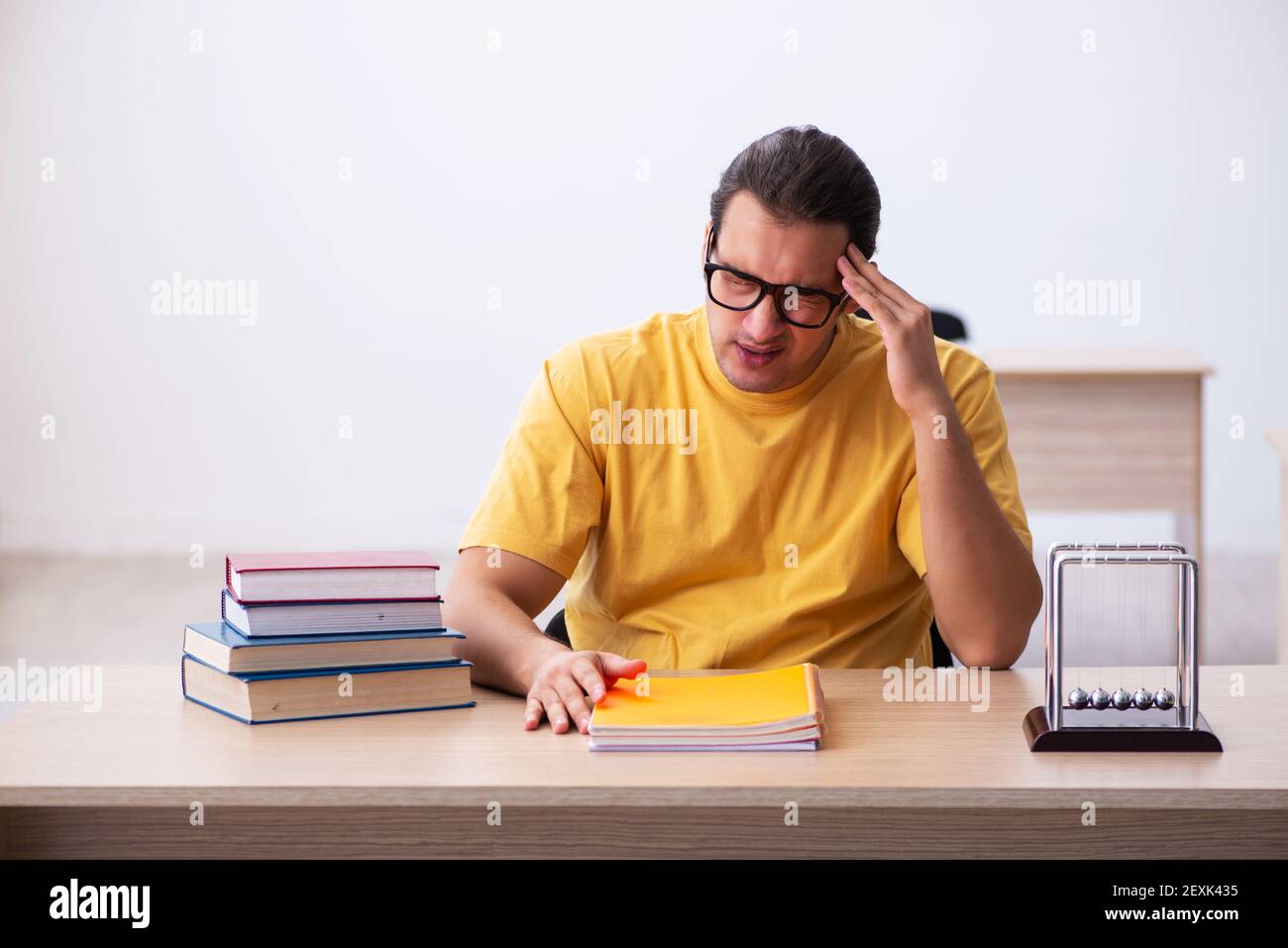 Young student physics preparing for exams in the classroom Stock Photo ...