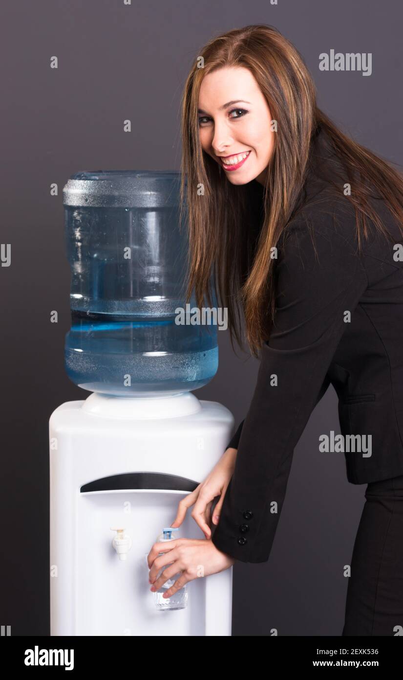 Woman standing water cooler hi-res stock photography and images - Alamy