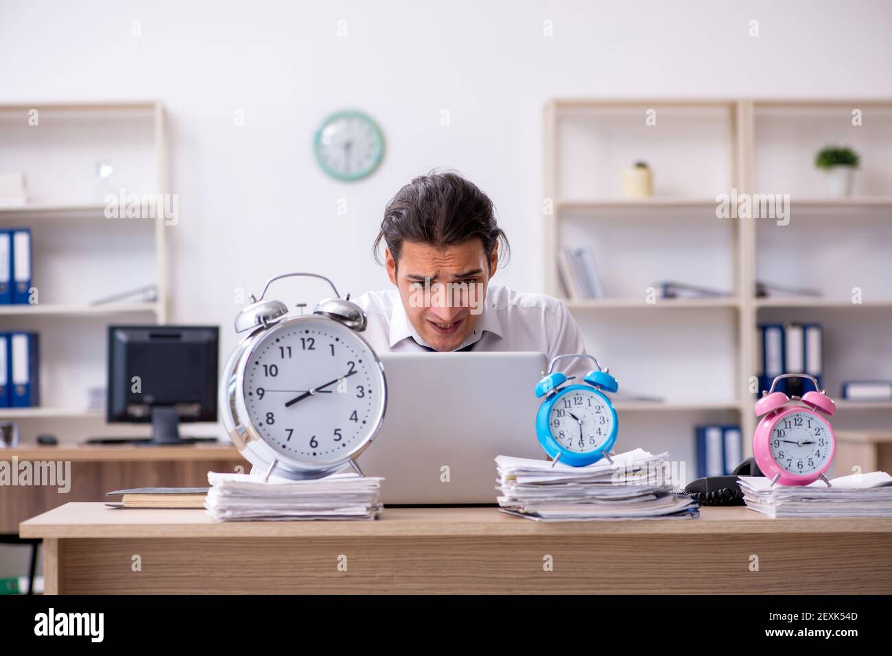 Young employee afraid of missing deadline at workplace Stock Photo - Alamy