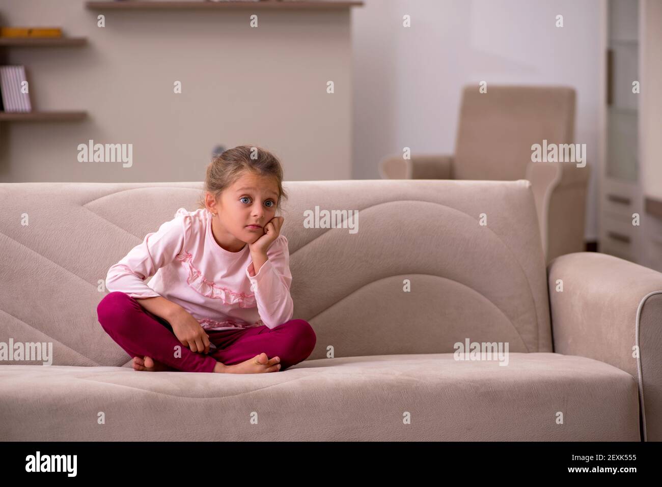 Little girl staying alone at home Stock Photo - Alamy
