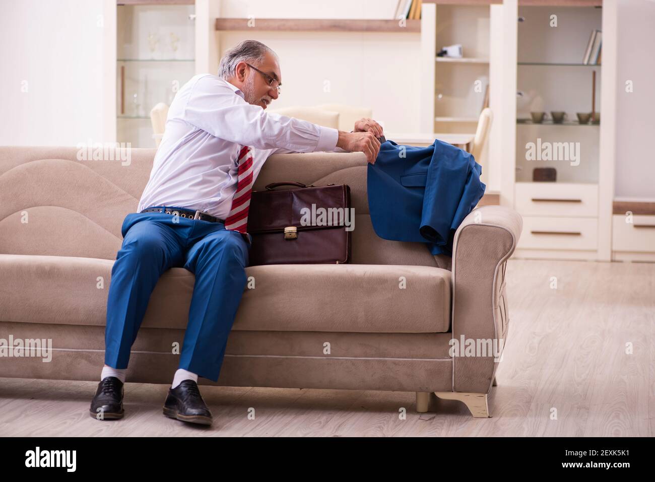 Senior male boss employee coming home from work Stock Photo - Alamy