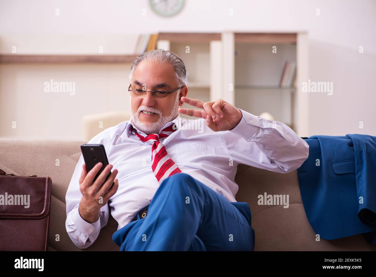 Senior male boss employee coming home from work Stock Photo - Alamy