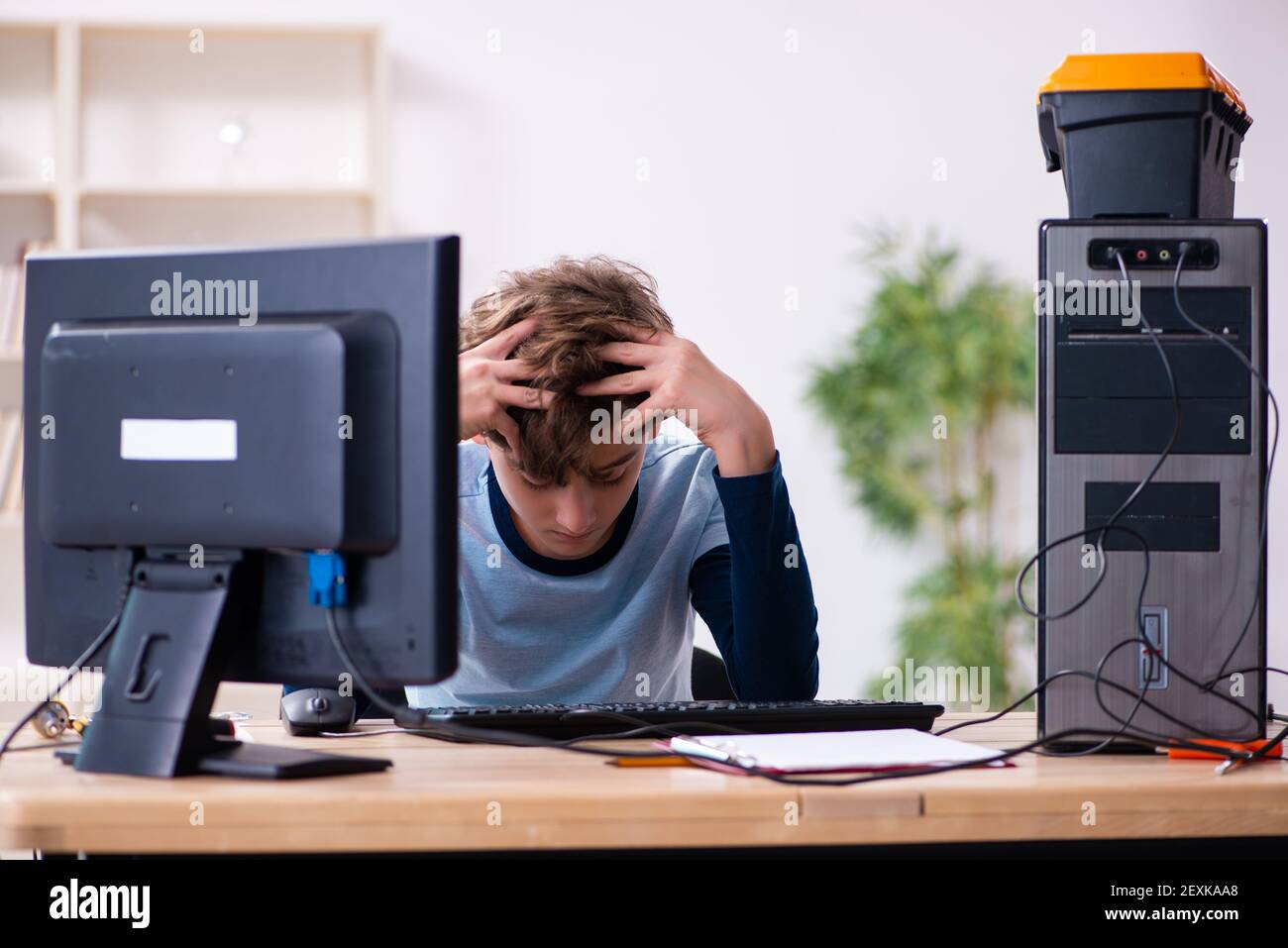 Teenager reparing computers at workshop Stock Photo - Alamy