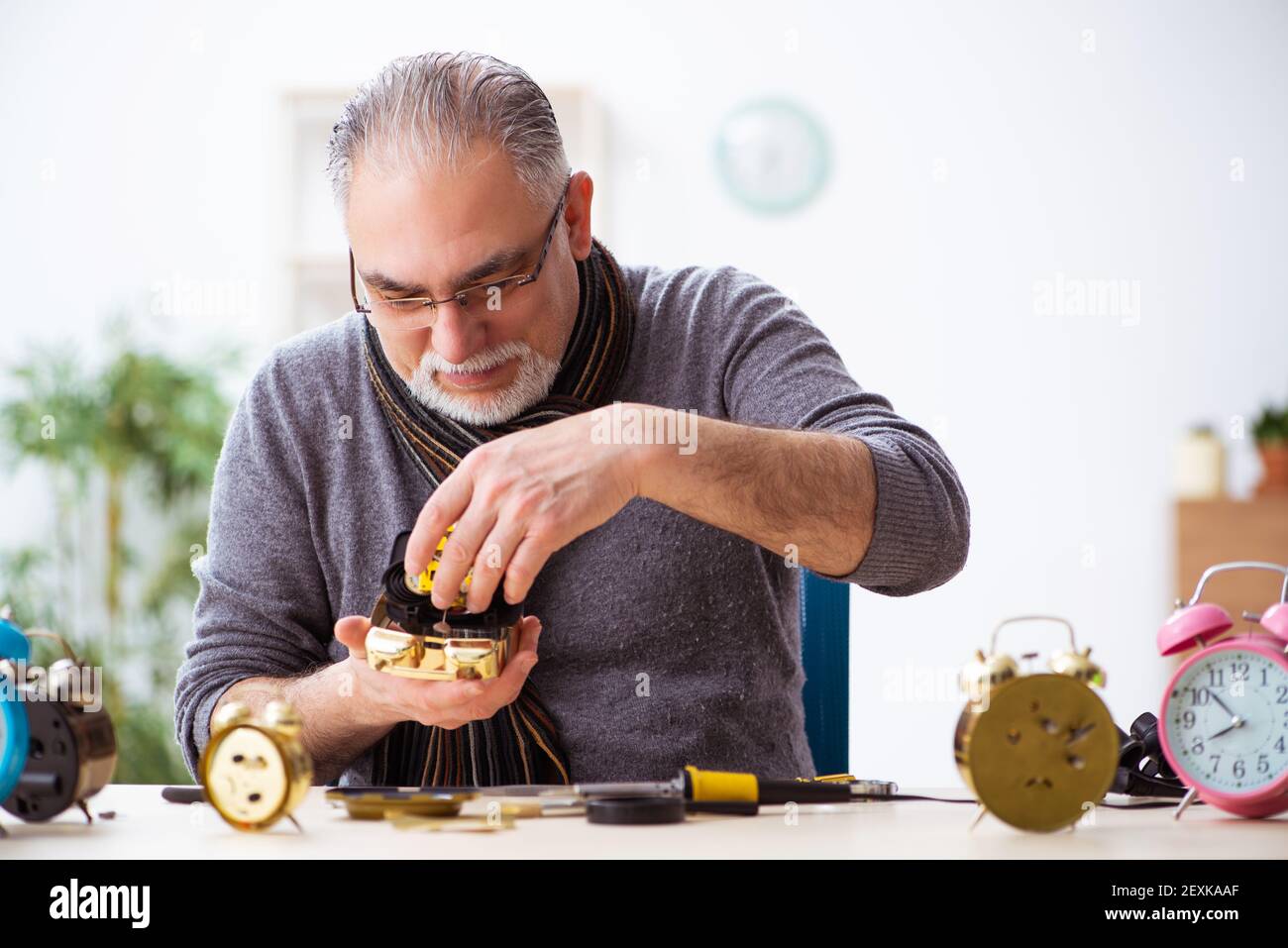 Old watchmaker working in the workshop Stock Photo - Alamy