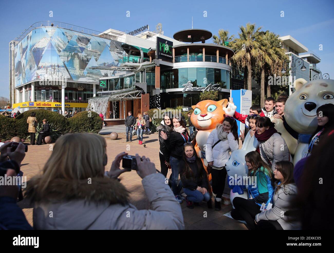 People stop to pose with the Olympic mascots in Sochi, Russia during ...
