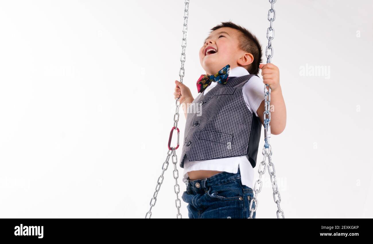 Happy Young Boy Plays Swing Suspended Moving Laughing Child Playtime ...