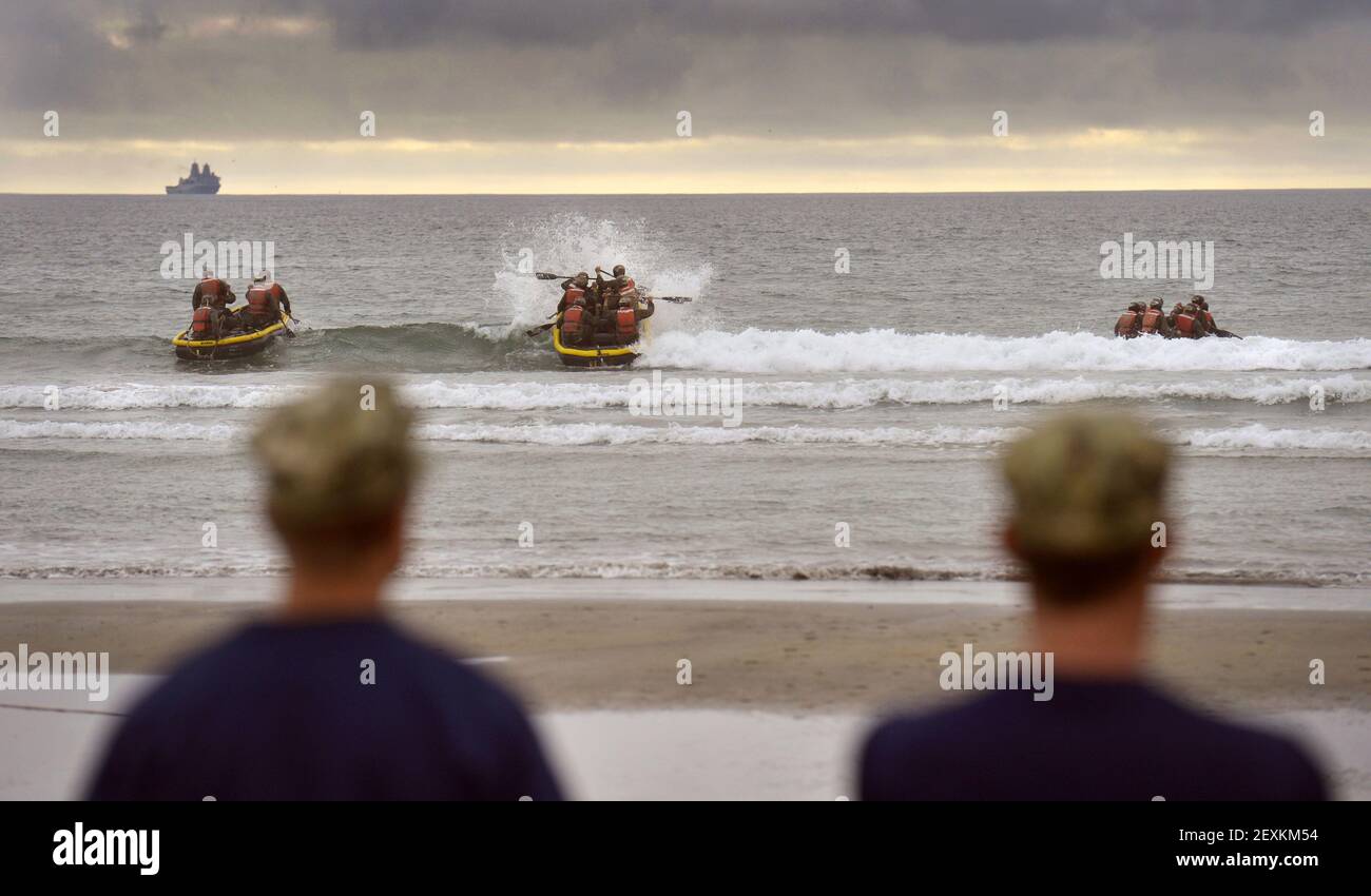 U.S. Navy SEAL candidates paddle inflatable boats into the incoming ...
