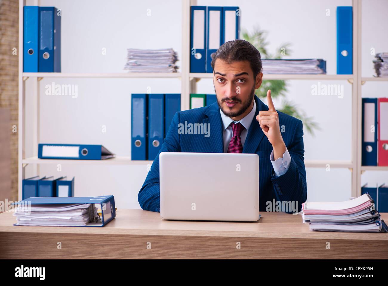 Young employee and too many work in the office Stock Photo - Alamy