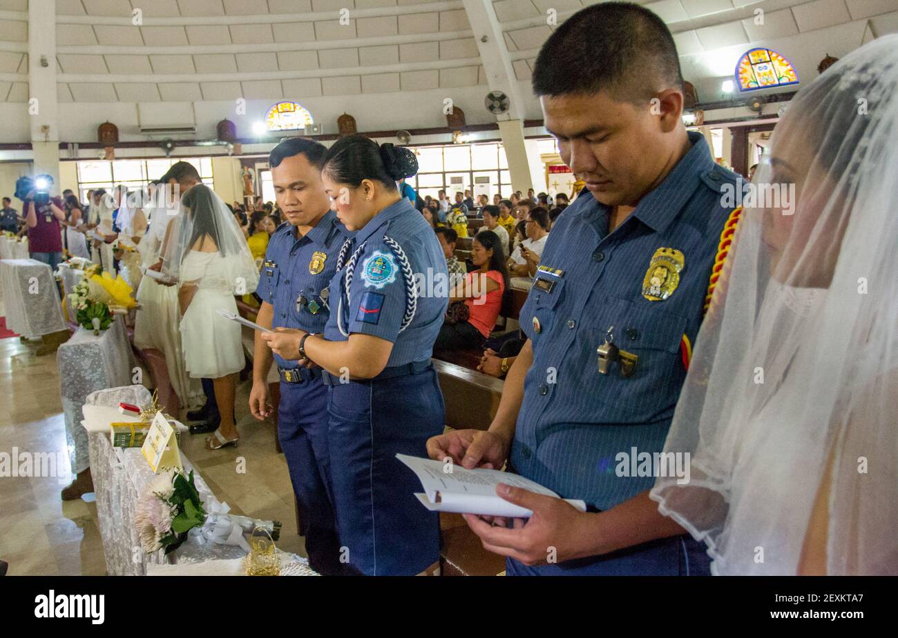 Quezon City, Philippines- February 14, 2014: Couples reading the oath ...