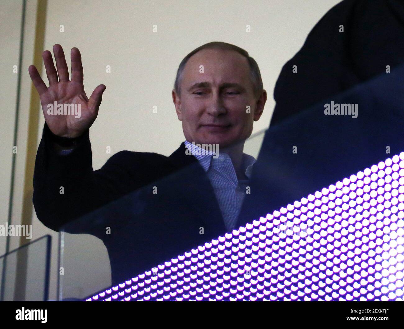 Russian President Vladimir Putin waves during a men's hockey game at ...