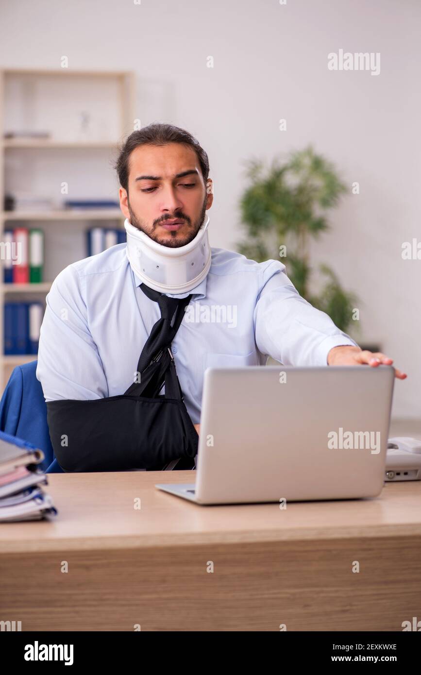 Young man employee after accident working in the office Stock Photo - Alamy