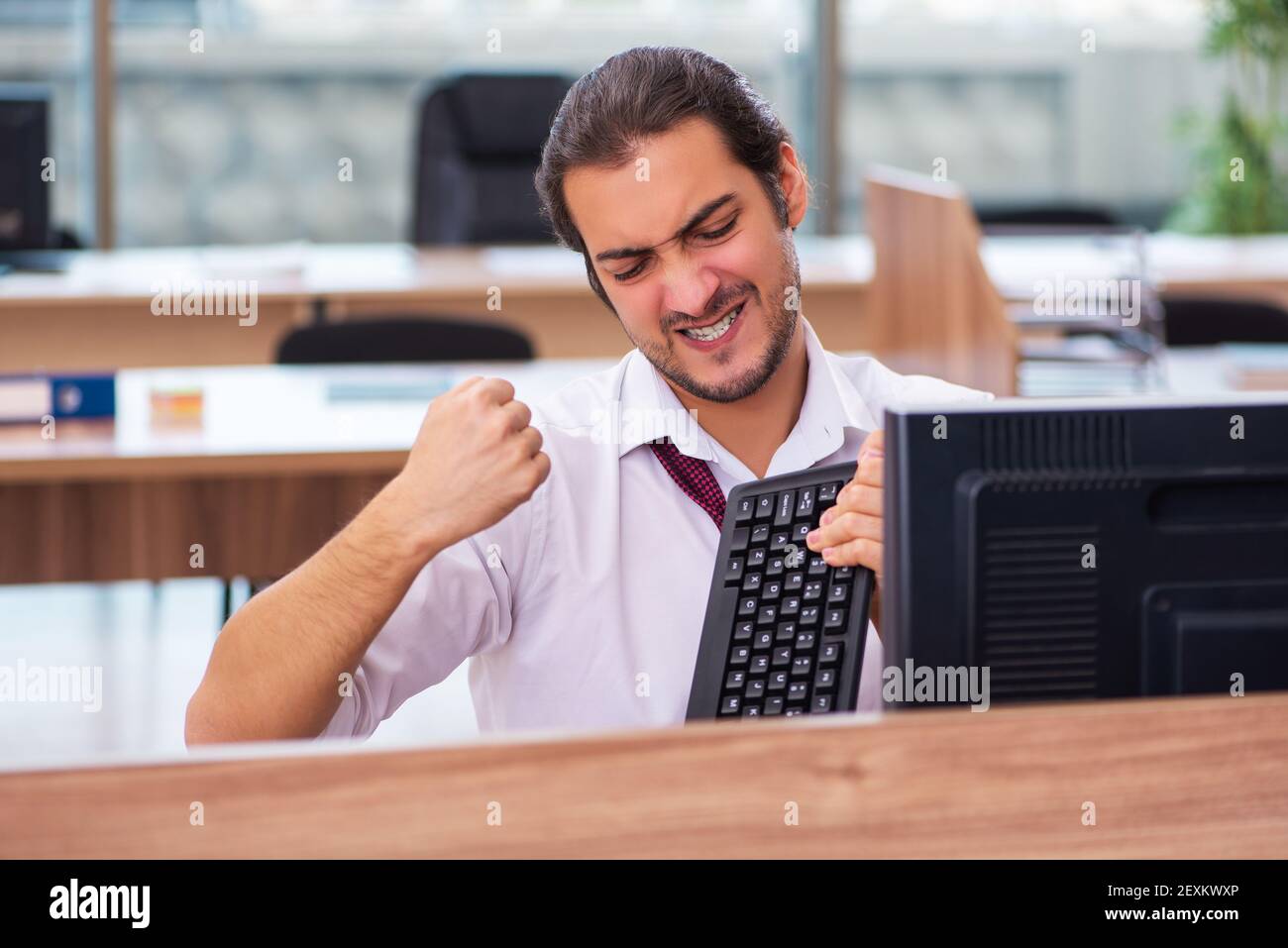 Young employee and too many work in the office Stock Photo - Alamy