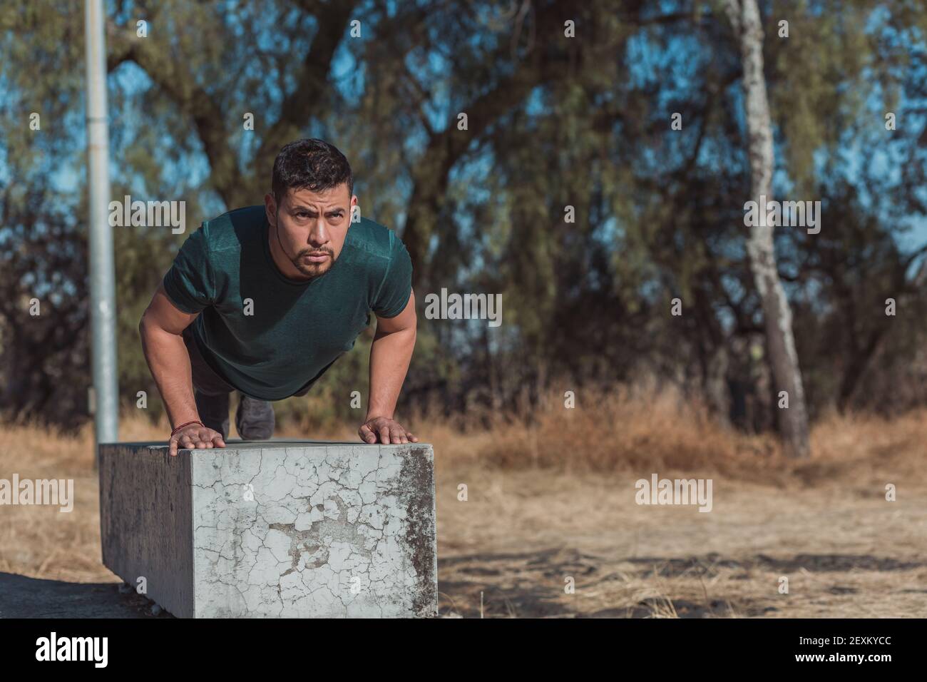 A closeup shot of a Hispanic male doing push-ups outdoor Stock Photo ...