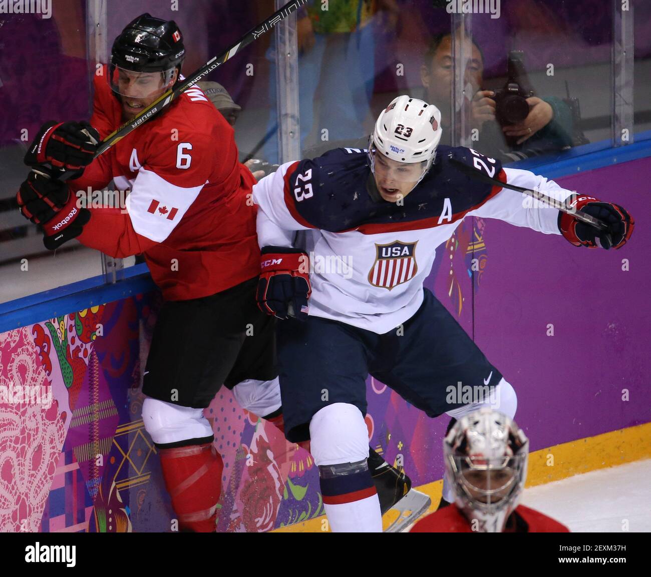 USA forward Dustin Brown (23) hits Canada defenseman Shea Weber (6) in ...