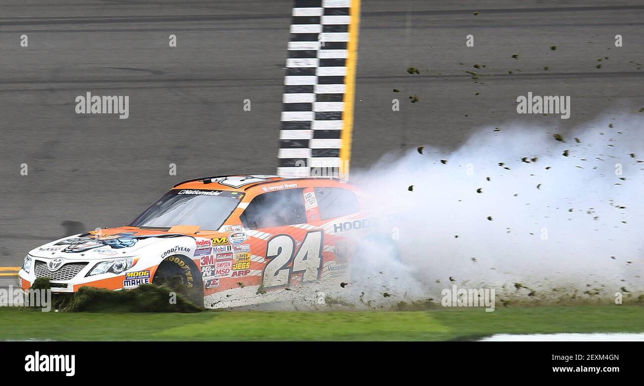 Harrison Rhodes (24) slides in the grass across the start/finish line ...