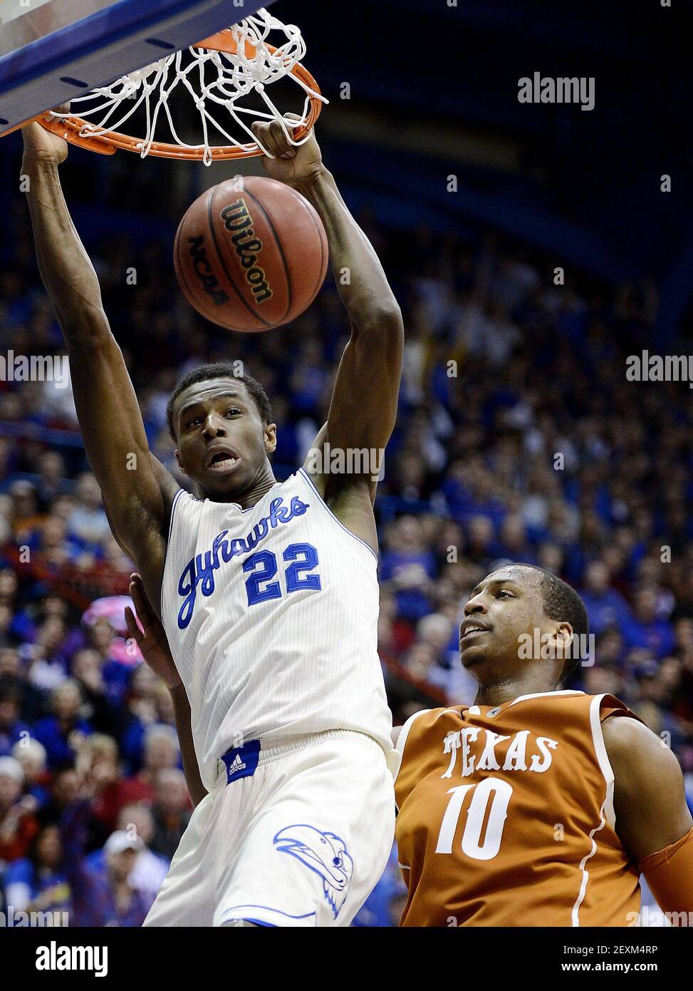Kansas' Andrew Wiggins dunks over Texas' Johnathan Holmes during the ...