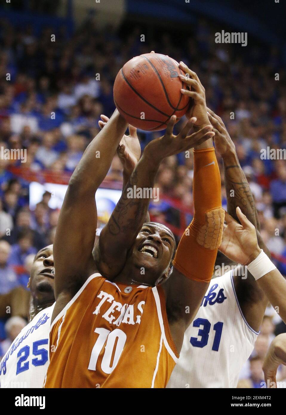 Texas' Jonathan Holmes (10) battles for a rebound with Kansas' Tarik ...