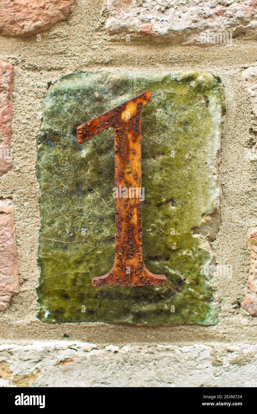 The number one on stone wall Stock Photo - Alamy