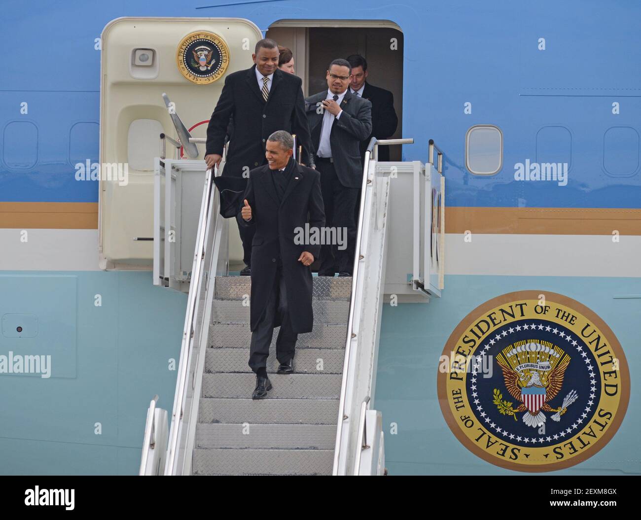 U.S. President Barack Obama is followed by staff as he exits Air Force ...