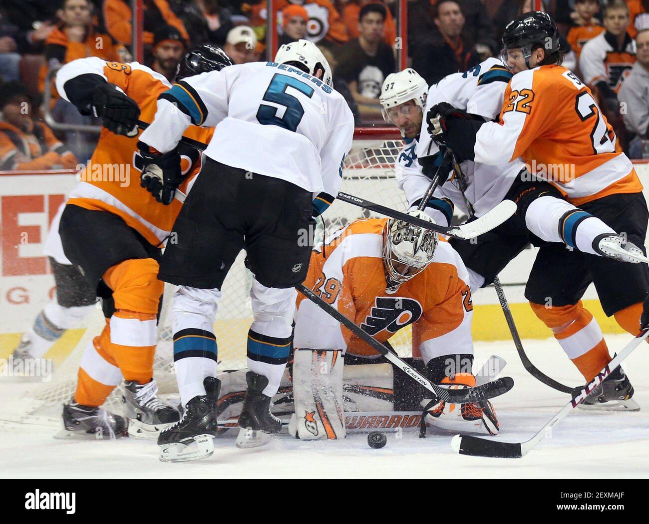Philadelphia Flyers goalie Ray Emery, middle, watches the puck against ...