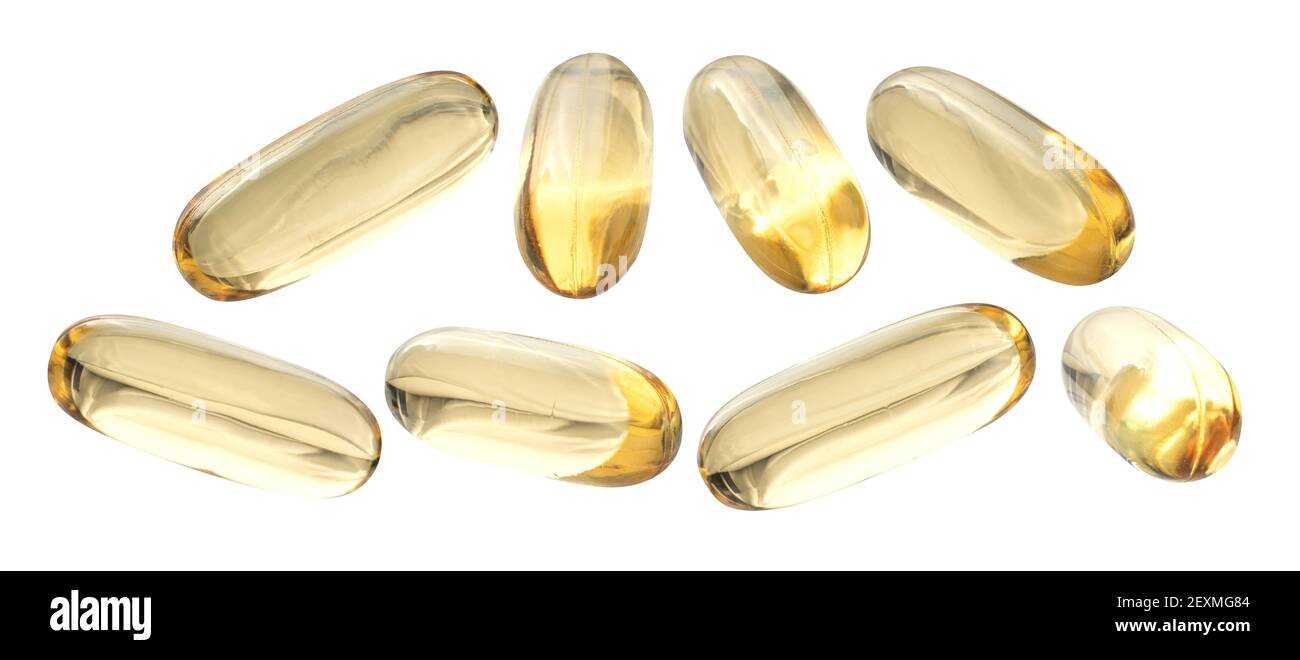 A set of yellow capsules. Isolated on a white background Stock Photo ...
