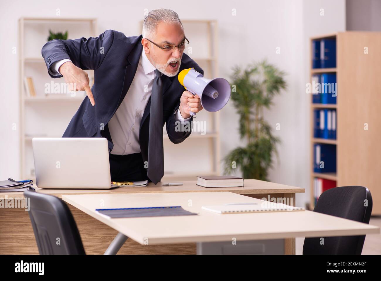 Old businessman employer holding megaphone Stock Photo - Alamy