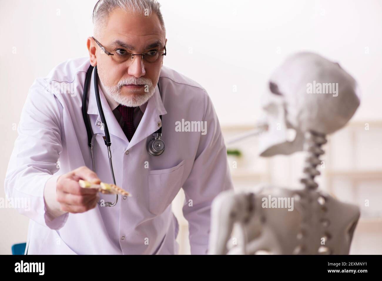 Skeleton cigarette addicted patient visiting old male doctor Stock ...
