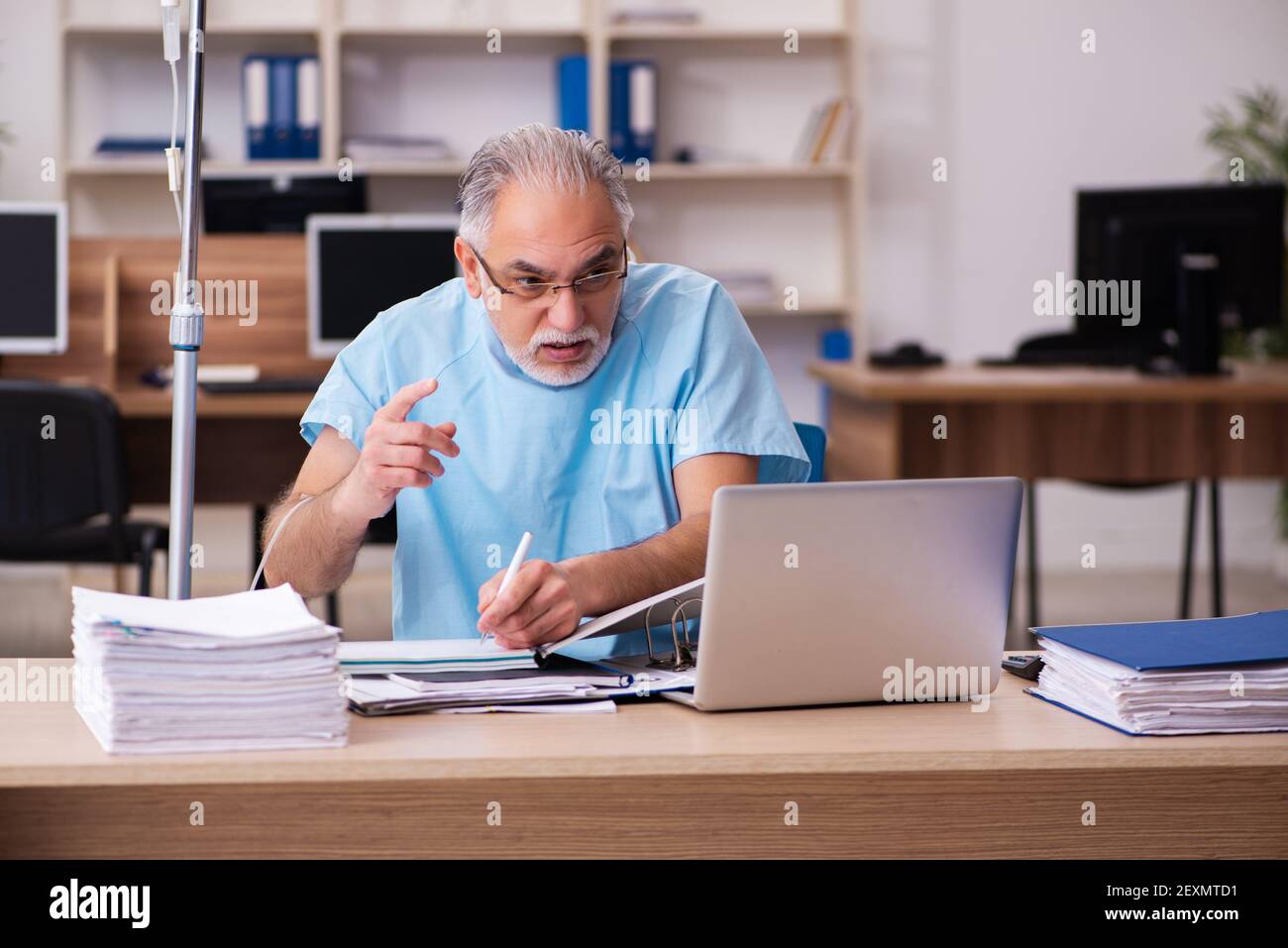 Old businessman employee in blood transfusion concept Stock Photo - Alamy