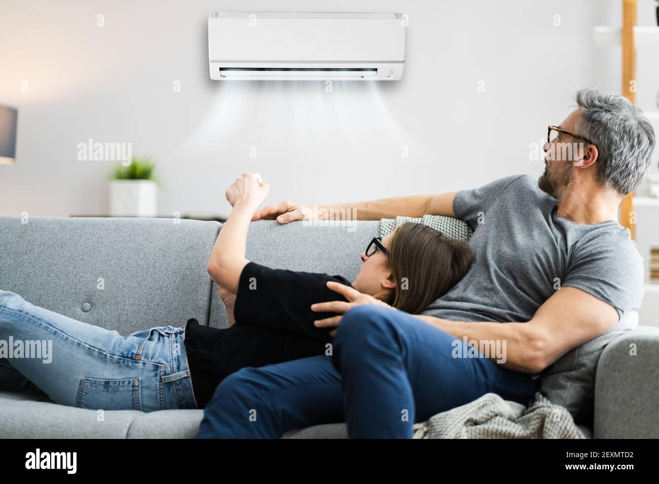 Happy Family Using Air Condition In House Stock Photo - Alamy