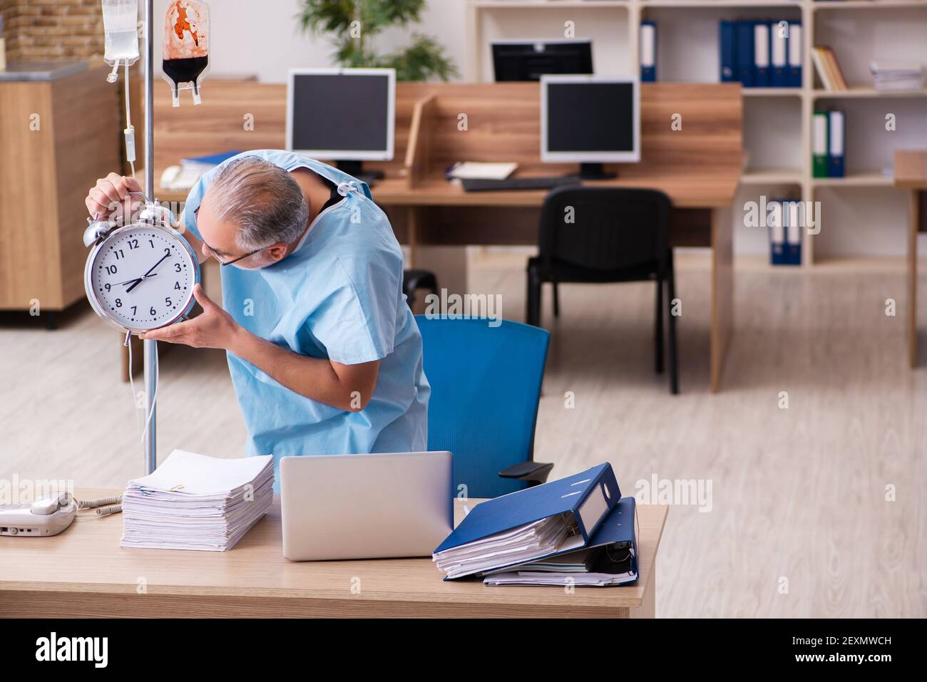 Old businessman employee in blood transfusion concept Stock Photo - Alamy
