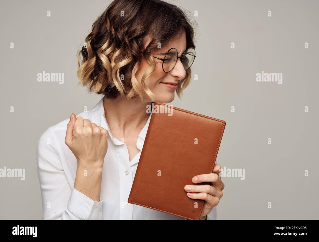 Business woman short hair white shirt and notepad in hand Stock Photo ...