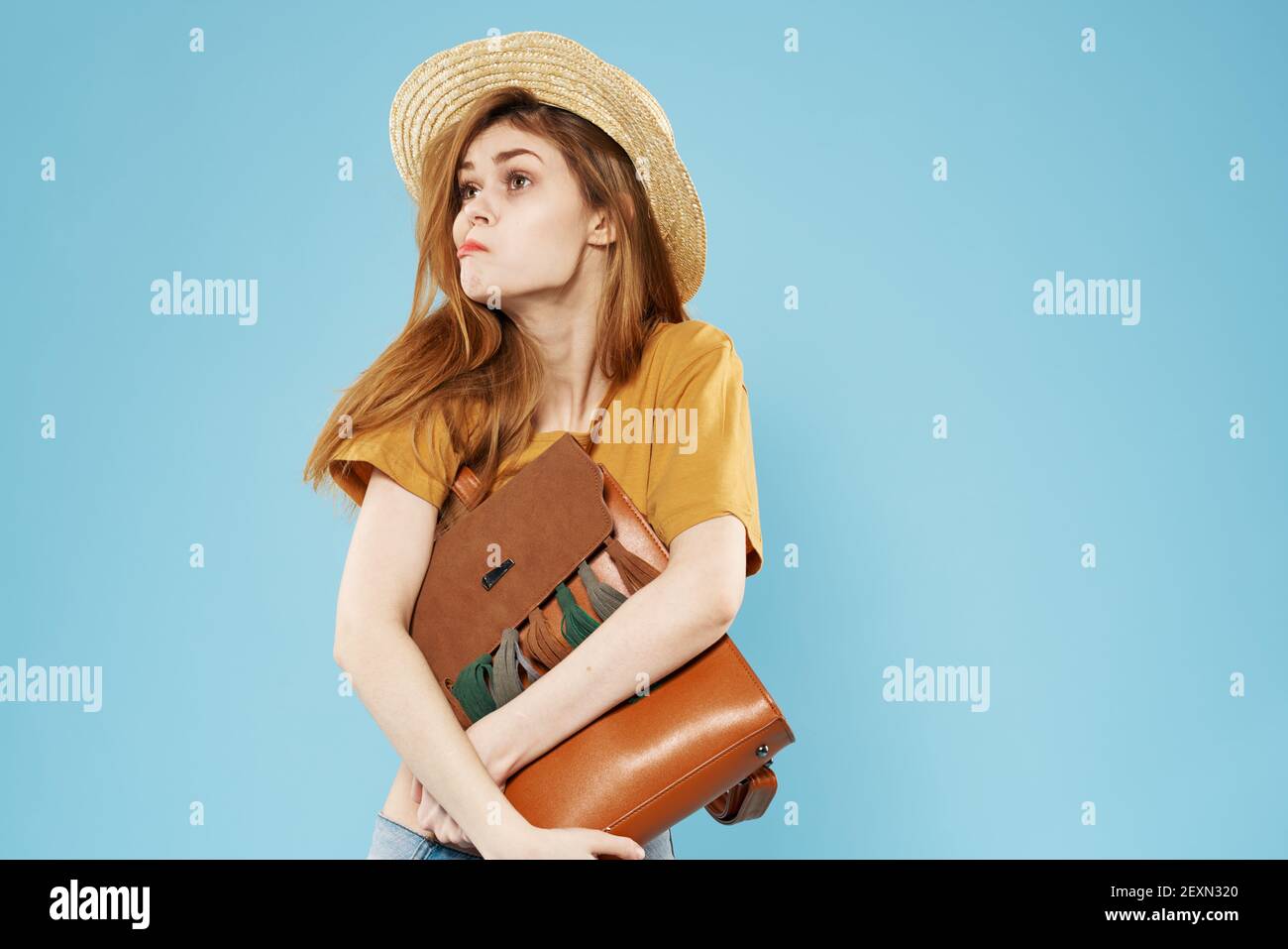 elegant woman hat backpack fashion studio charm models Stock Photo - Alamy